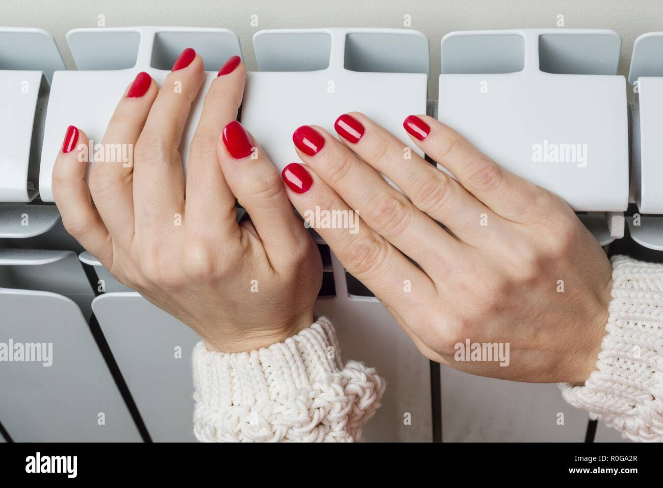 Woman with hand on radiator hi-res stock photography and images - Alamy