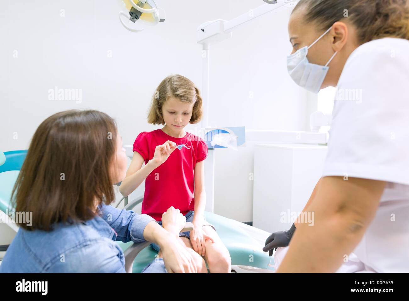Mother and little daughter visiting dentist at dental clinics ...