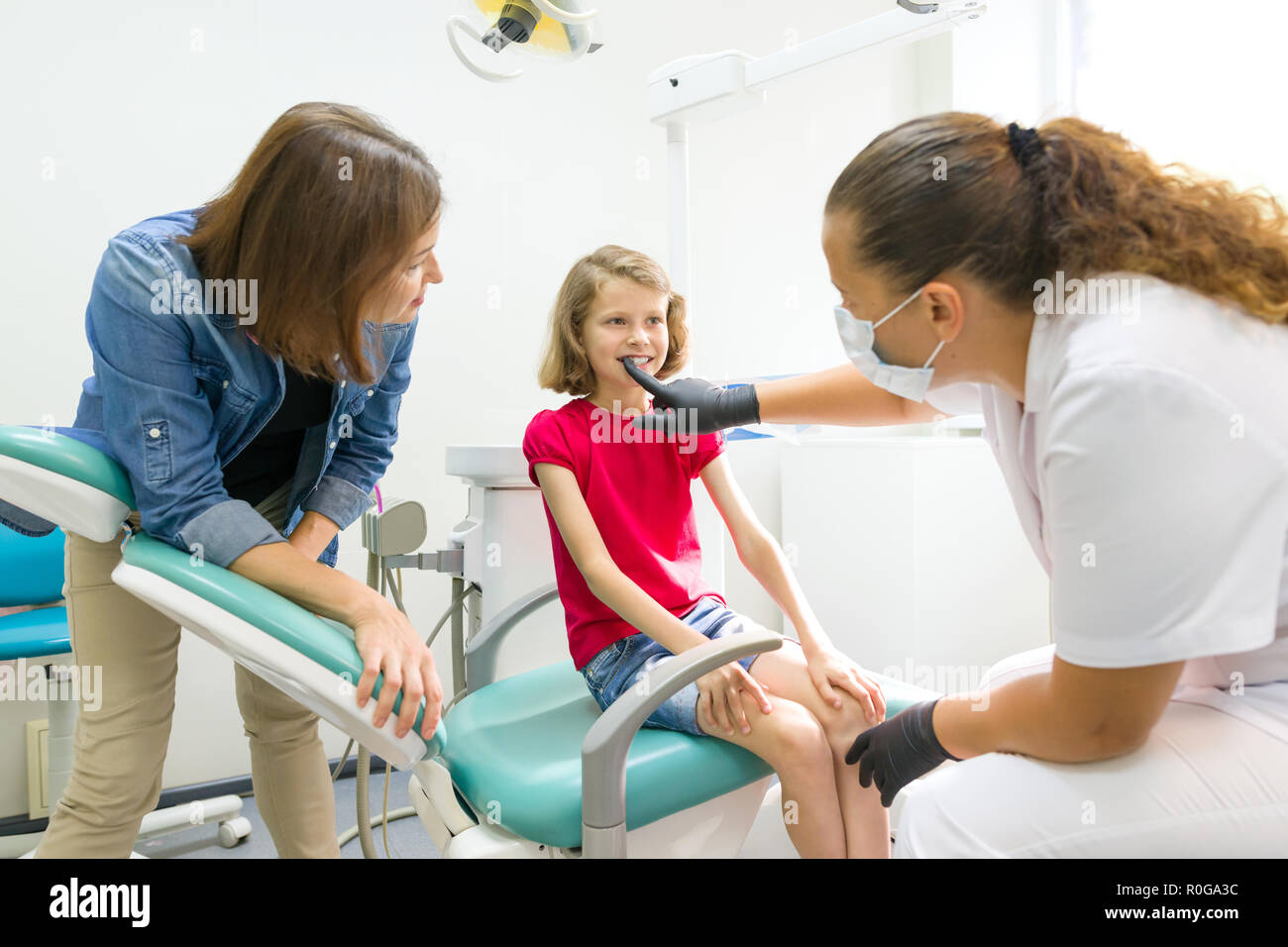 Mother and little daughter visiting dentist at dental clinics ...