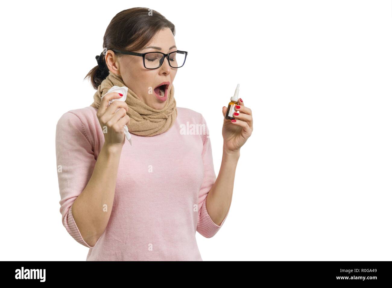 Sick woman holding a handkerchief and nasal spray. White background ...