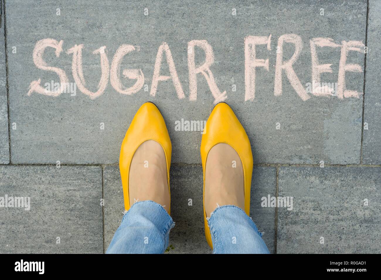 Female feet with text sugar free written on grey sidewalk Stock Photo ...