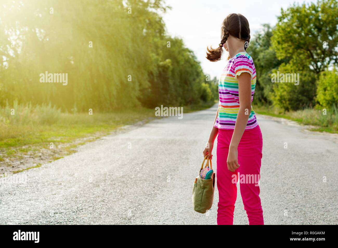 Summer vacation. Girl traveler on the road. Stand with back Stock Photo ...