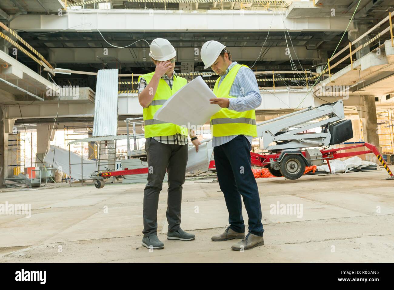 Group of engineers, builders, architects on the building site ...