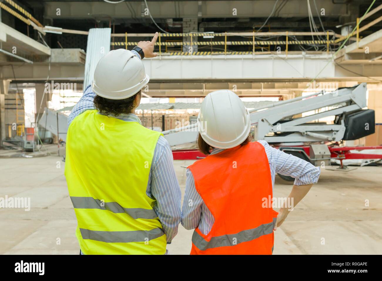 Man engineer and woman architect at a construction site. Building ...