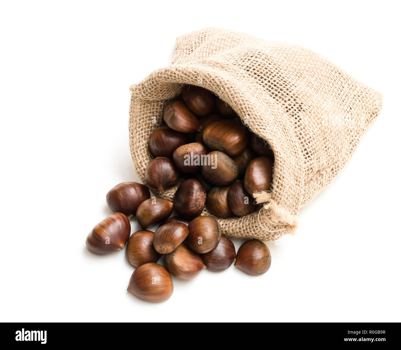 Fresh chestnuts in sack bag on white background Stock Photo - Alamy