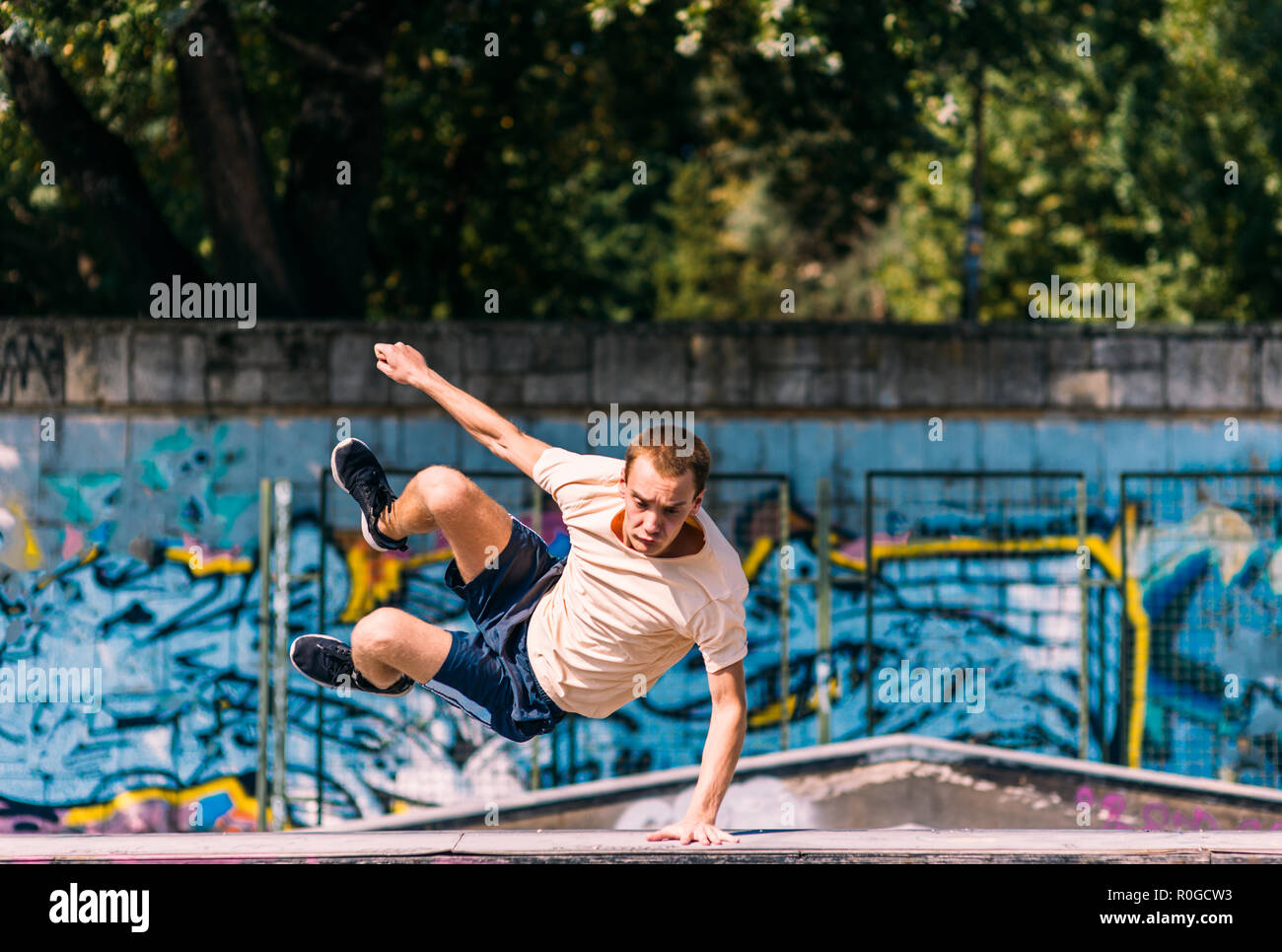 Free runner practicing jumping over obstacles in skatepark Stock Photo ...