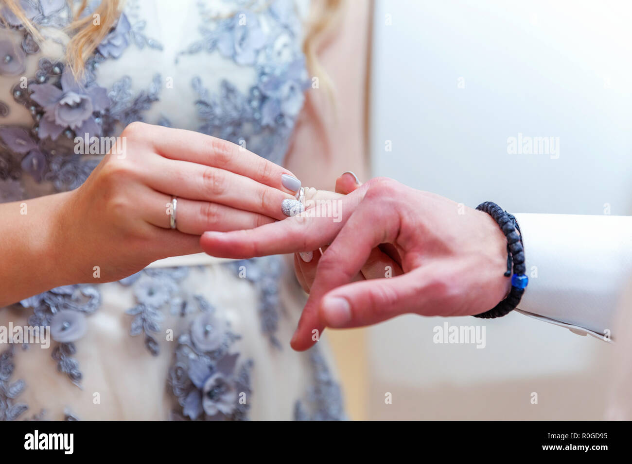 Bride and groom marriage hands with wedding rings. Bride hand putting ...