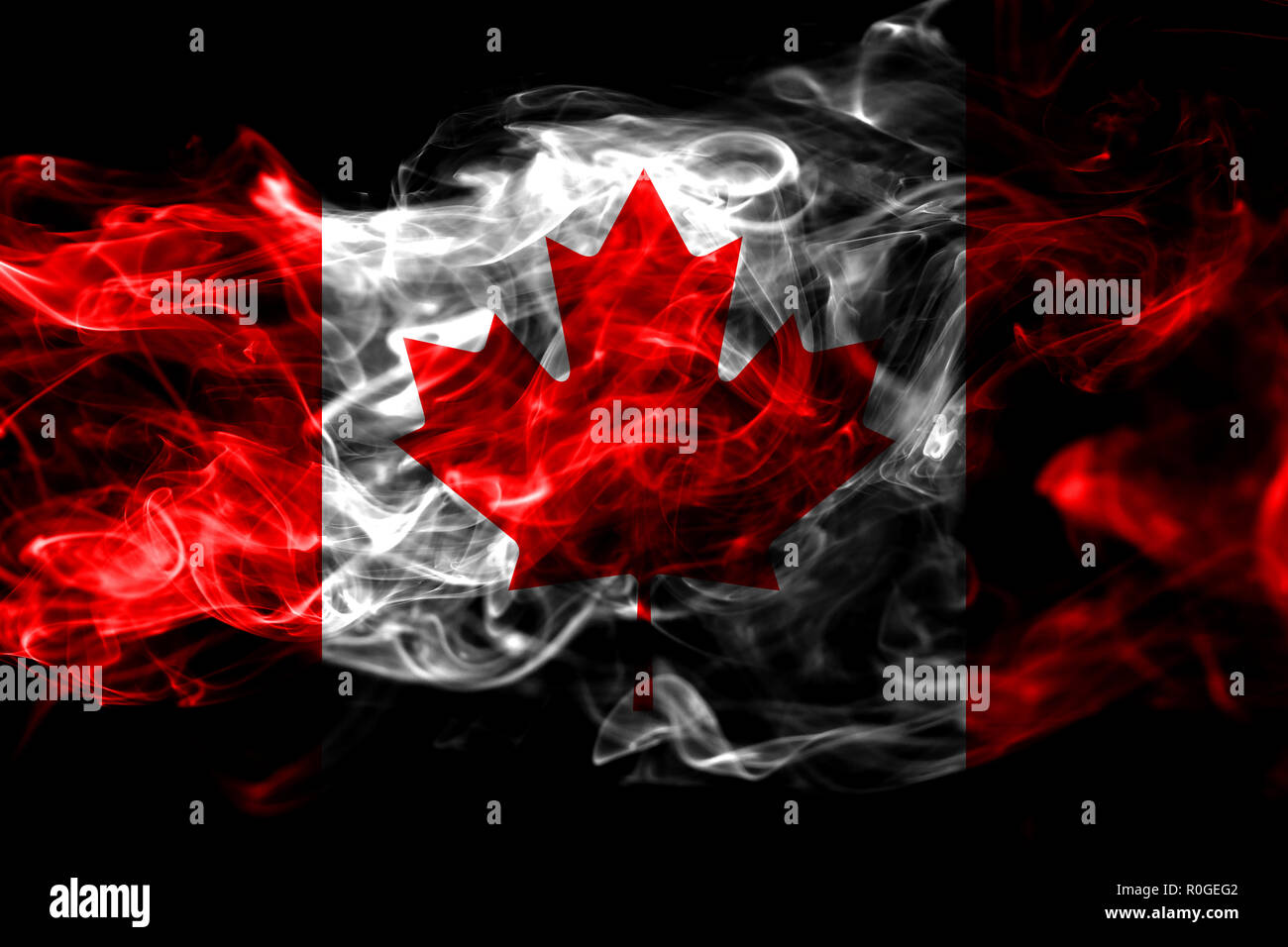 National flag of Canada made from colored smoke isolated on black ...