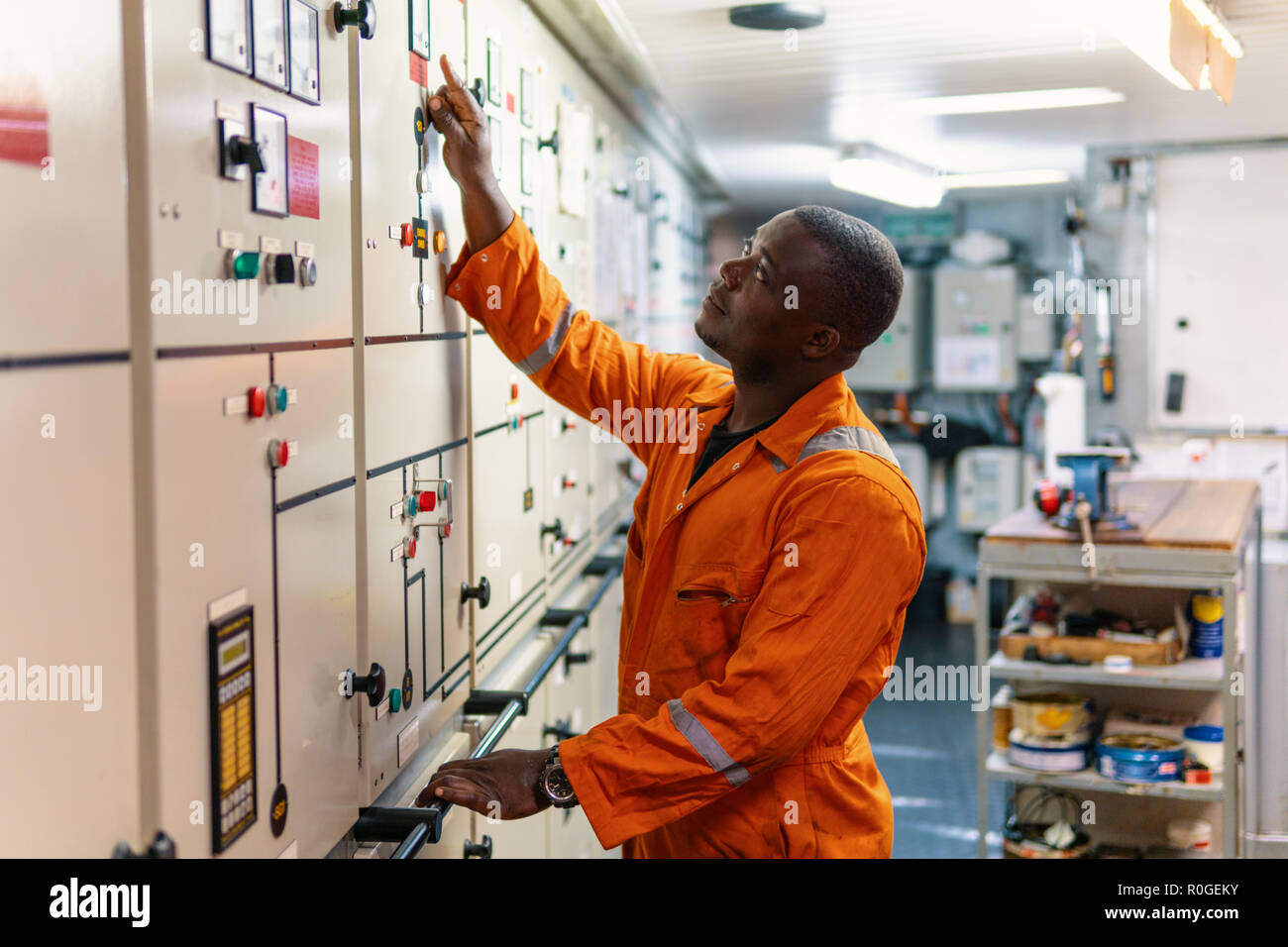 Marine engineer officer working in engine room Stock Photo - Alamy