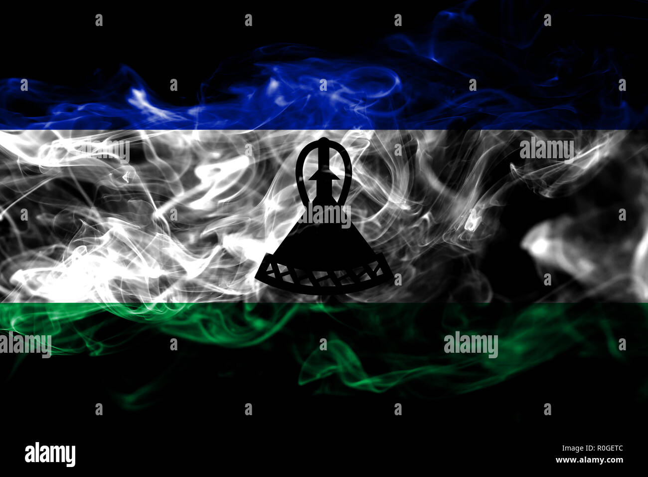 National flag of Lesotho made from colored smoke isolated on black ...