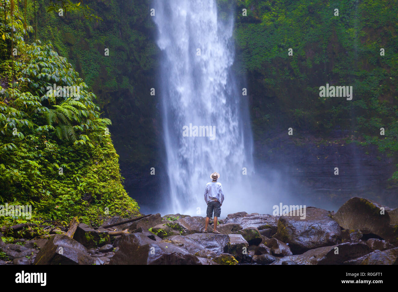 Tourist enjoying at beautiful waterfall Stock Photo - Alamy