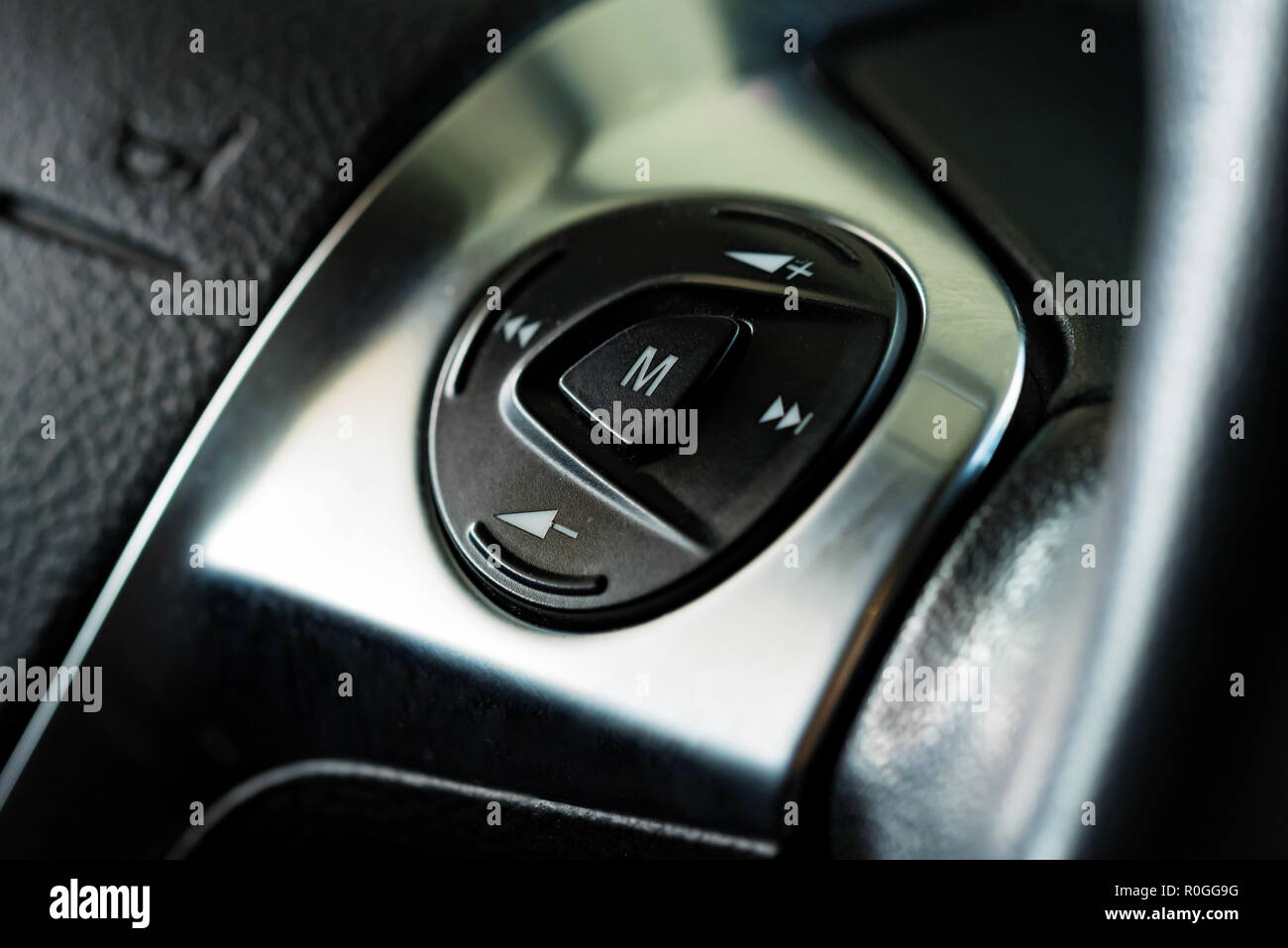 Multimedia control buttons on steering wheel in modern car Stock Photo ...
