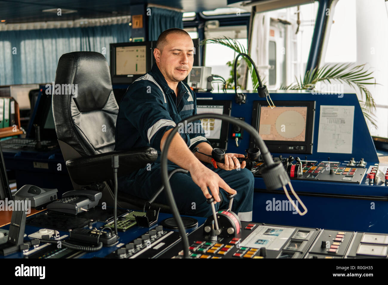 Marine navigational officer is maneuvering ship or vessel Stock Photo ...