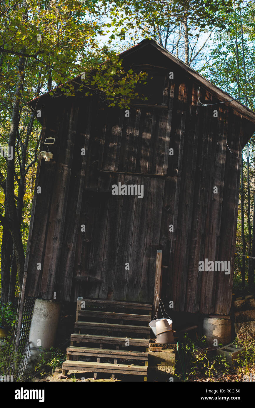 An old, farm grainery leans on it's foundation in a rural are a of ...