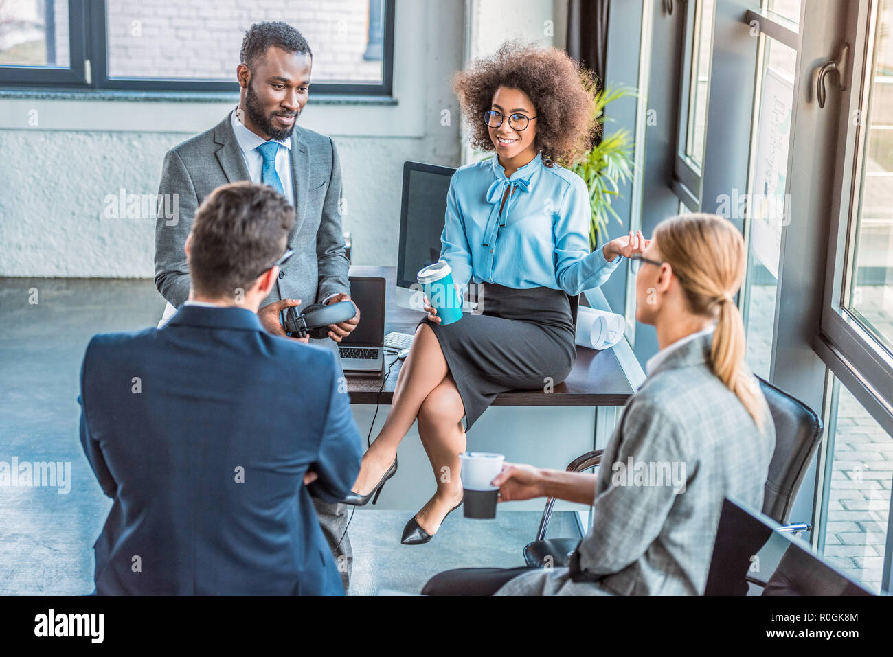 high angle view of multicultural businesspeople having coffee break in ...