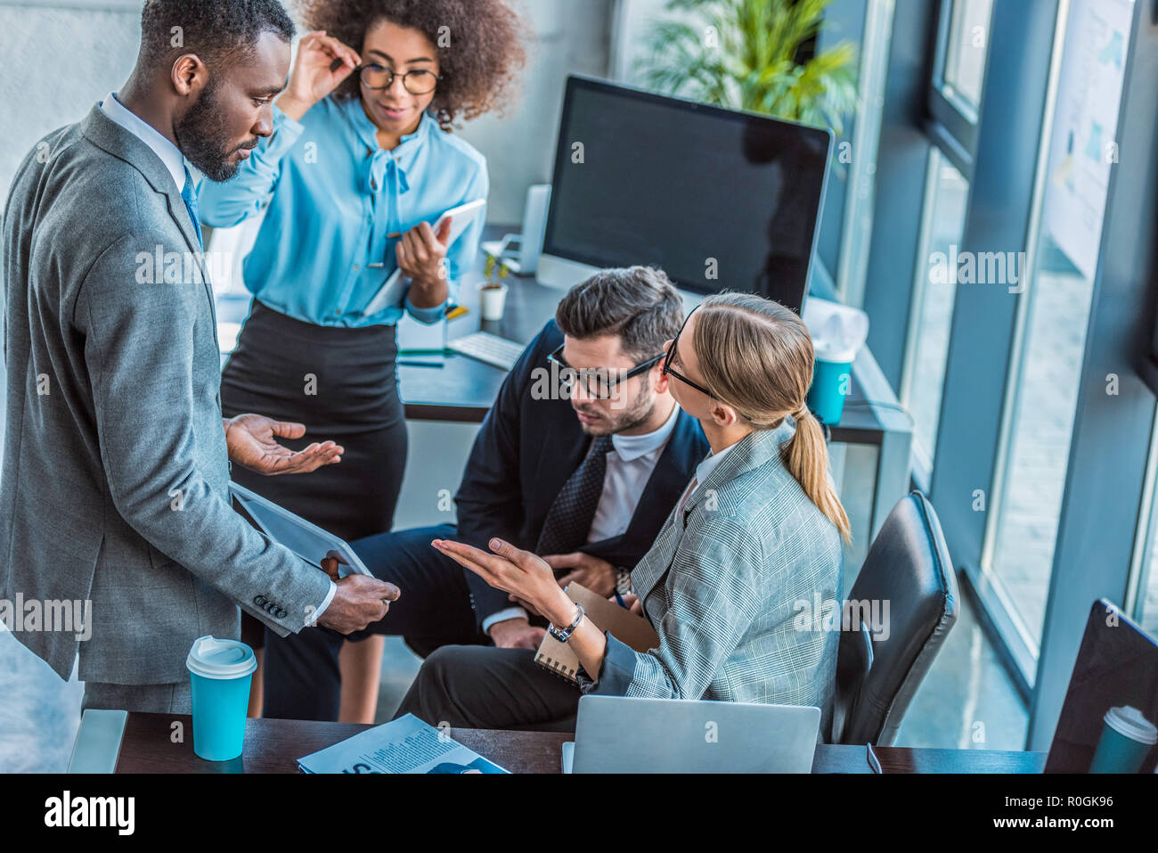 multicultural businesspeople having conversation in office Stock Photo ...