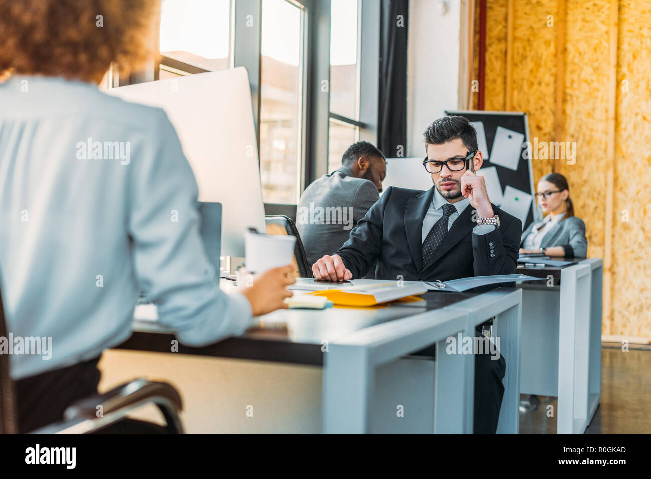 Multicultural businesspeople working tables hi-res stock photography ...