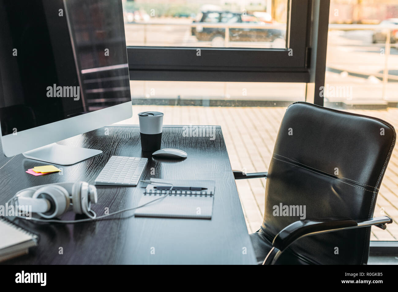 table with computer and cup of coffee in business office Stock Photo ...