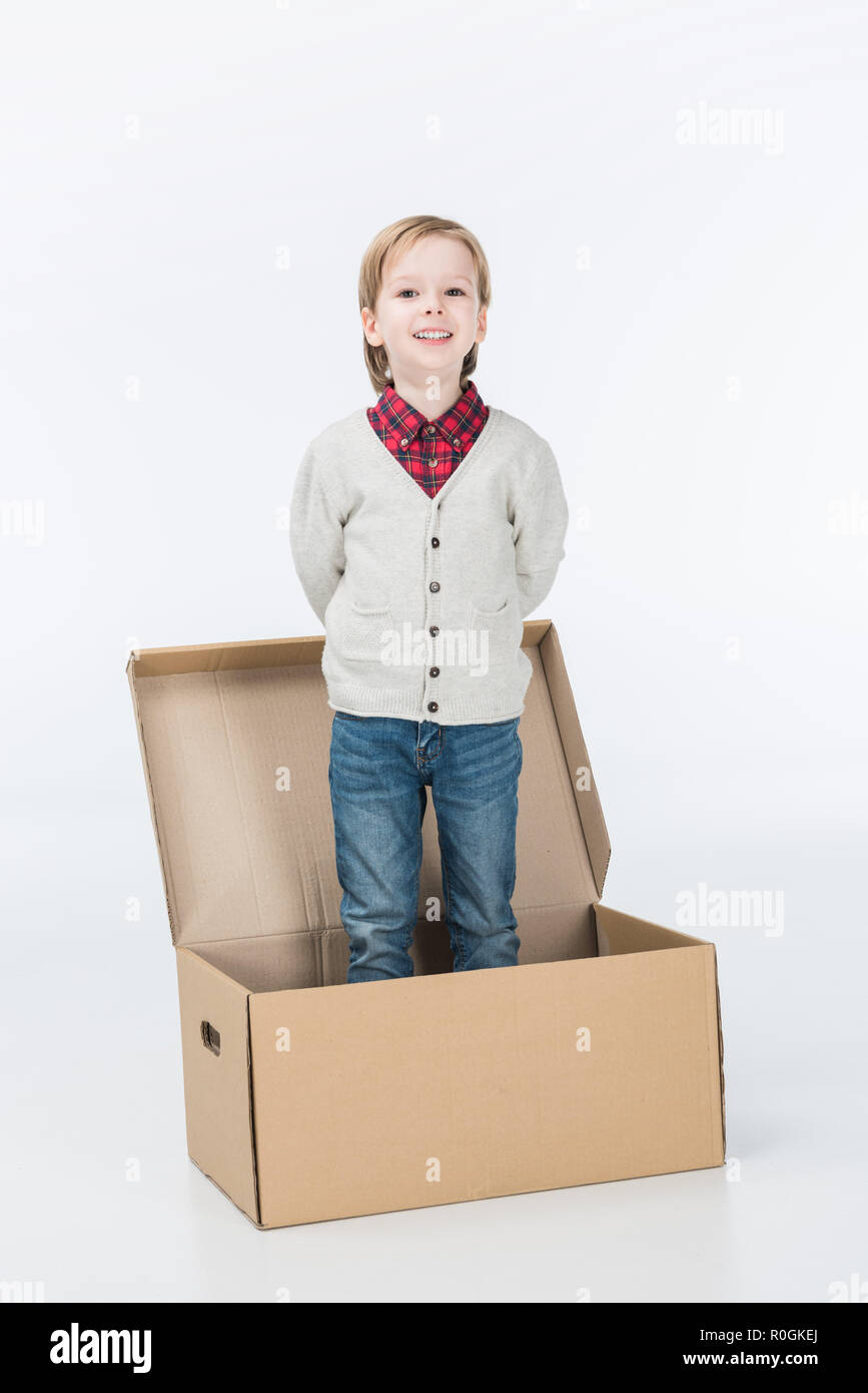 smiling boy standing in cardboard box isolated on white Stock Photo - Alamy