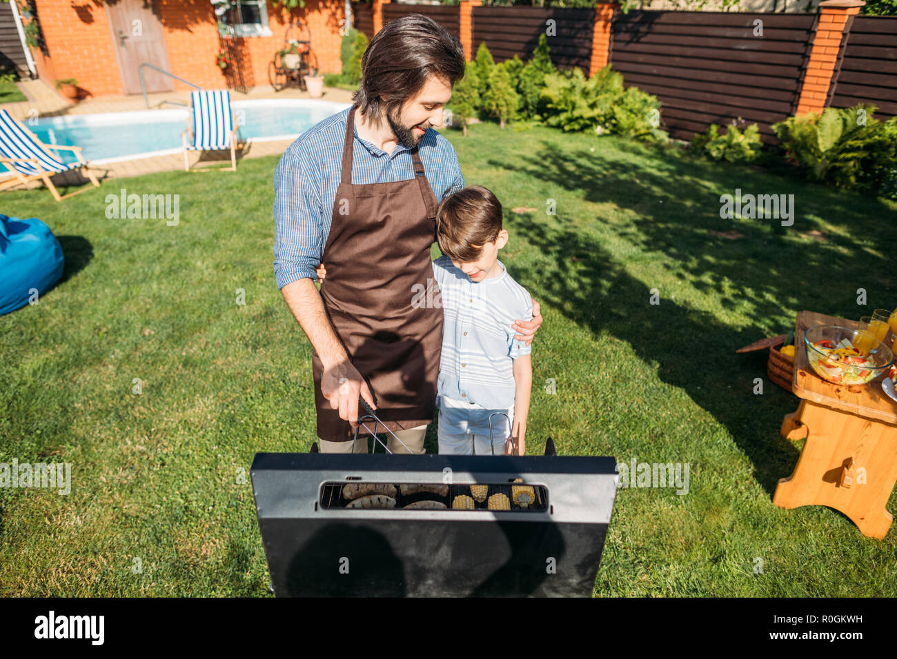 Backyard grill father son hi-res stock photography and images - Alamy