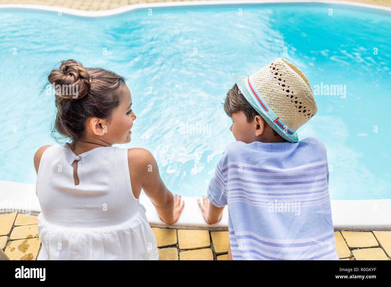 Friends sitting near pool hi-res stock photography and images - Alamy