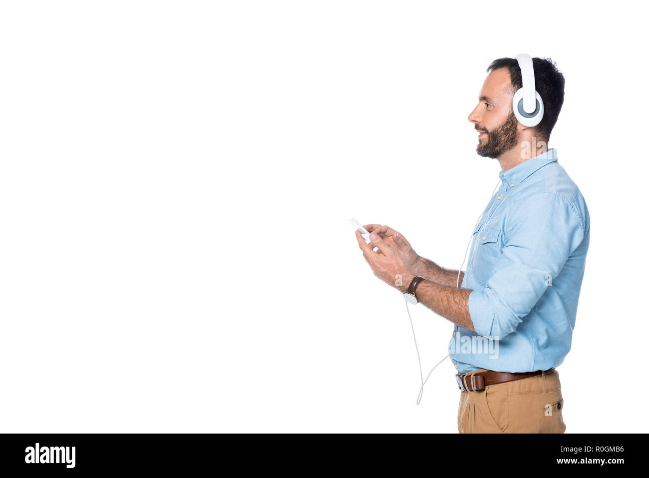 side view of smiling man listening music isolated on white Stock Photo ...