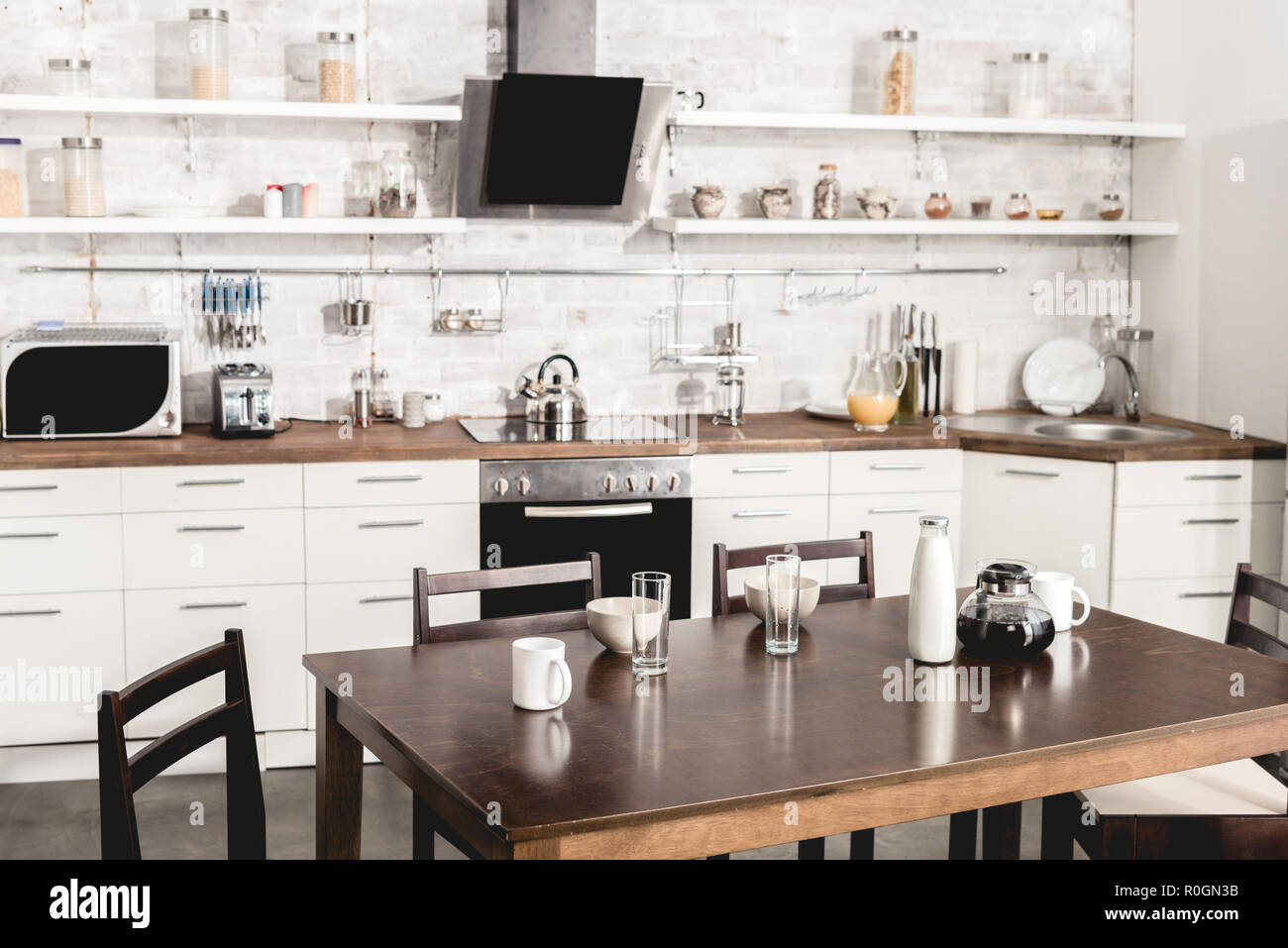 interior of modern white kitchen with table ready for breakfast Stock ...