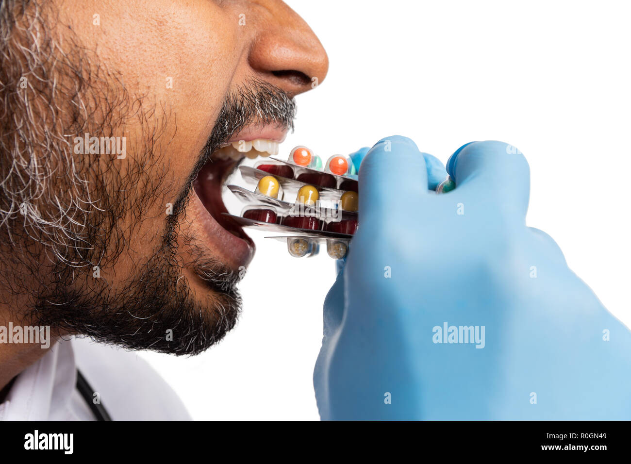 Close-up of indian male doctor or medic eating pill blisters isolated ...