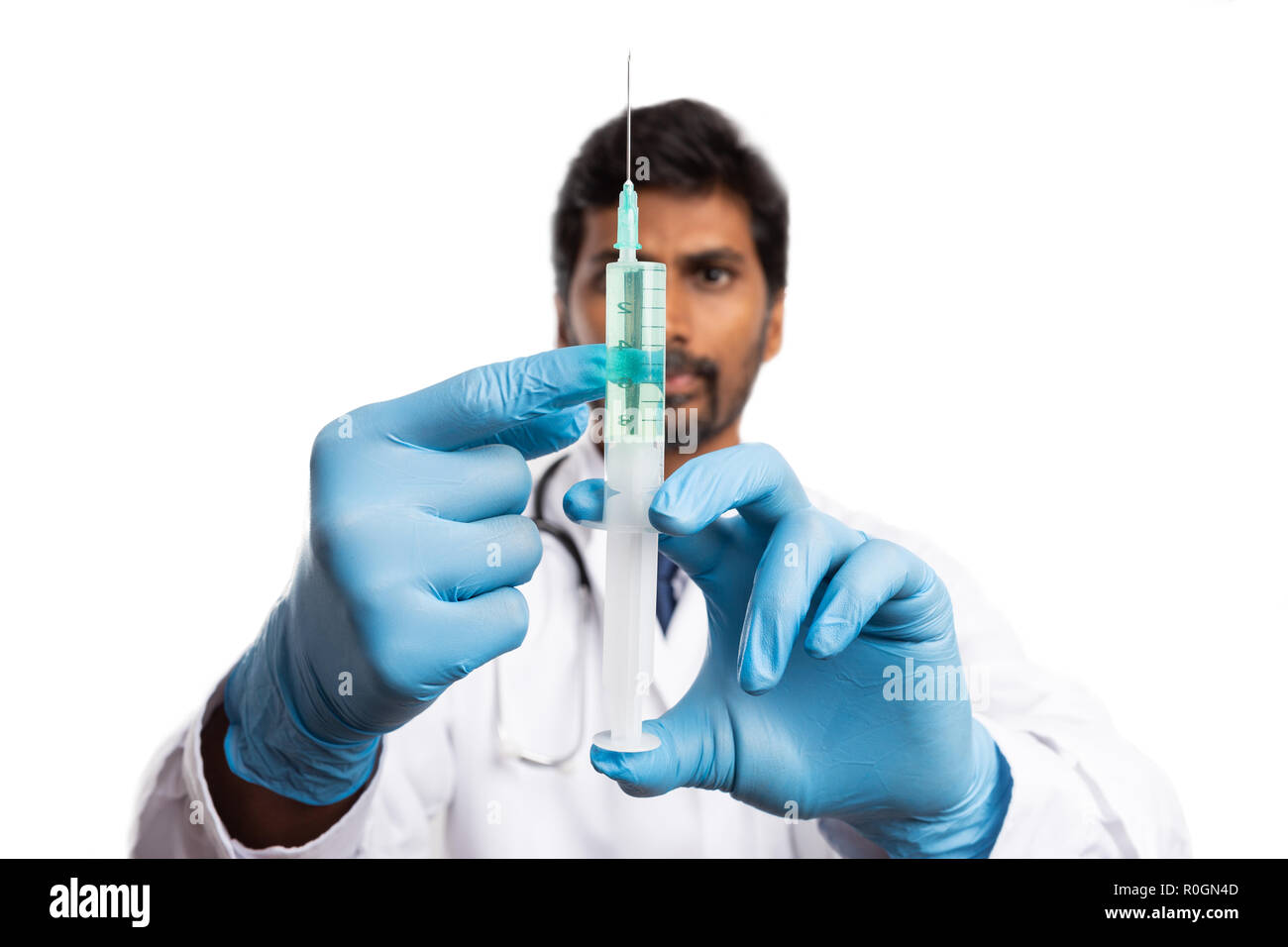 Indian male medic checking syringe with vaccine close-up isolated on ...