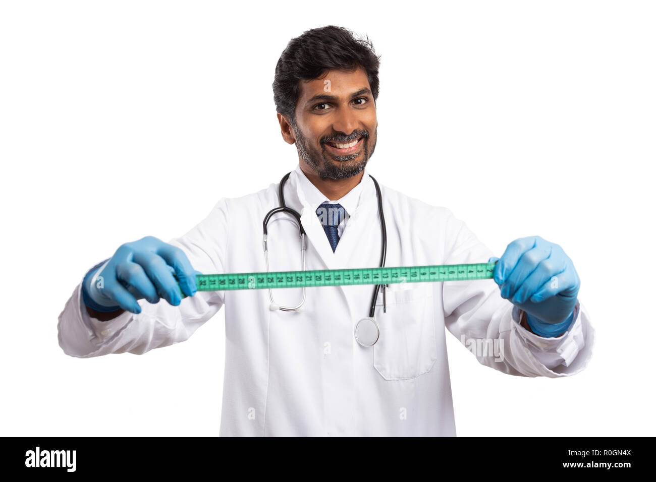 Indian doctor man measuring body size with tape isolated on white ...