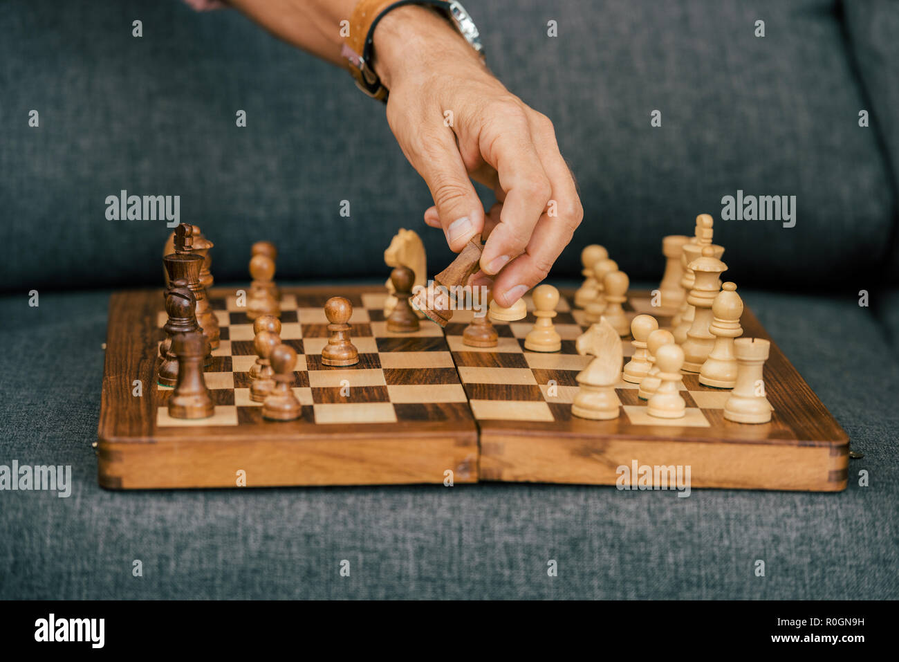 close-up partial view of man playing chess on couch Stock Photo - Alamy