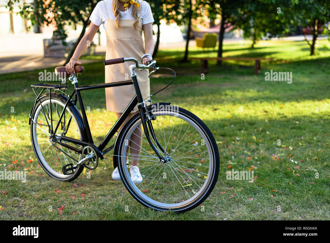 partial view of woman with retro bicycle standing in park Stock Photo ...