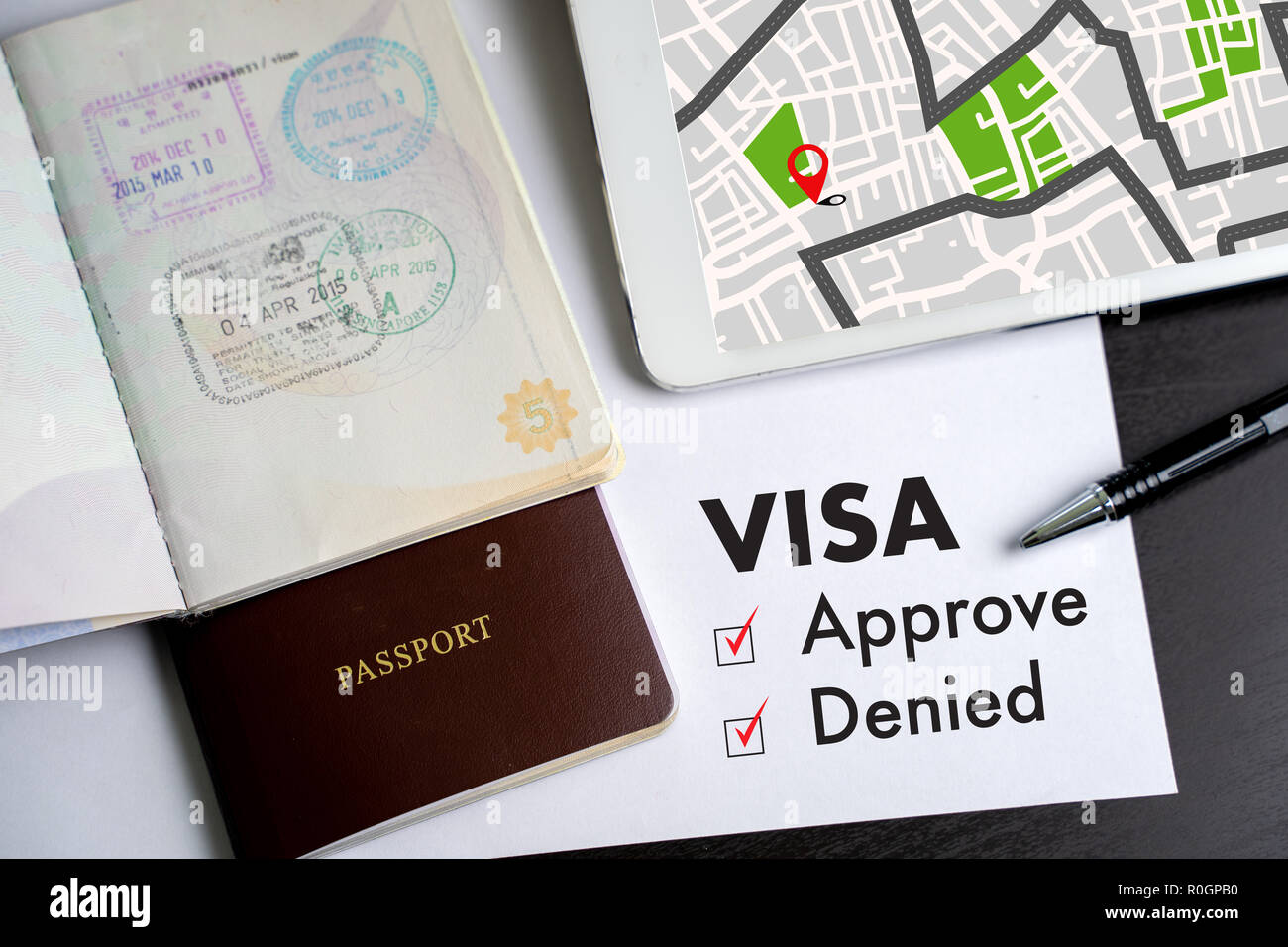 Visa and passport to approved stamped on a document top view in ...