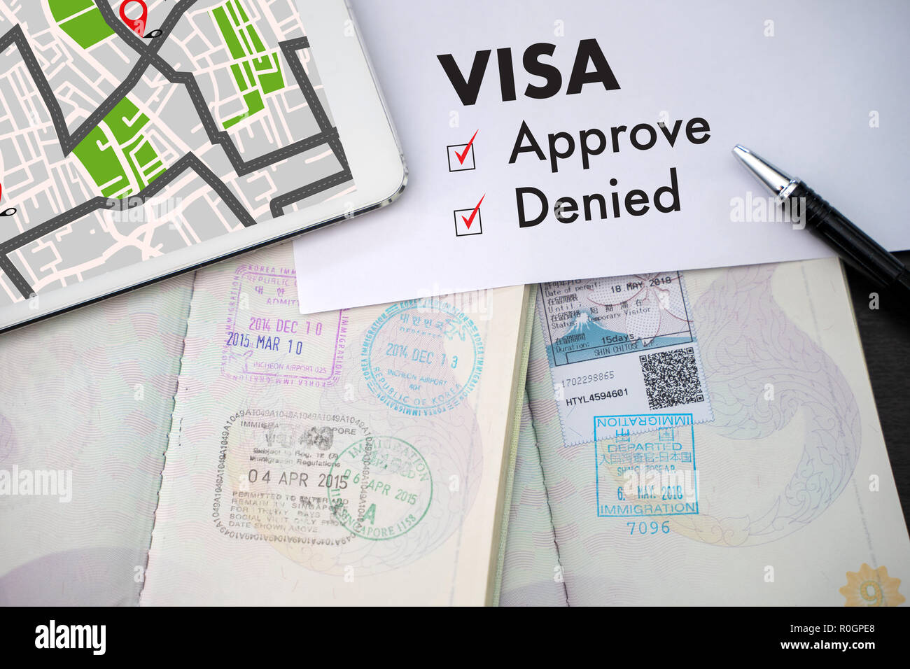 Visa and passport to approved stamped on a document top view in ...