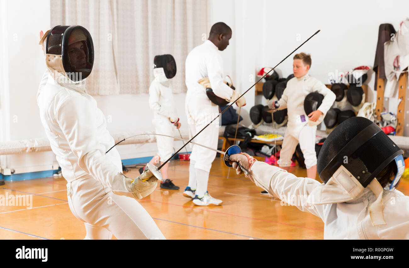 man and boy at fencing workout, training attack movements in duel Stock ...