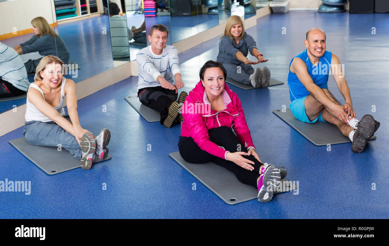 Group of positive adults doing pilates routine in a sport club Stock ...