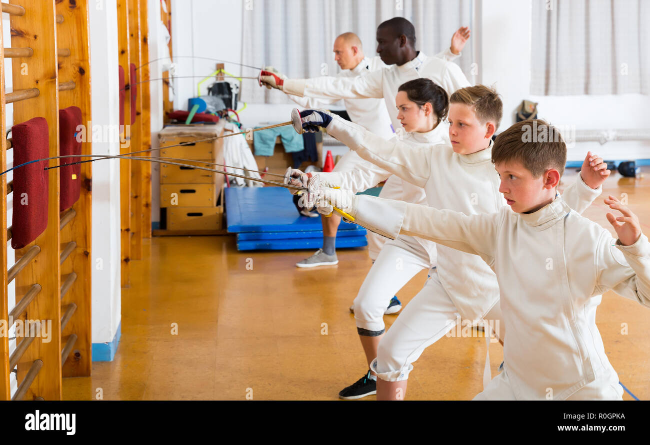 fencers athletes of different ages practicing fencing technique on ...