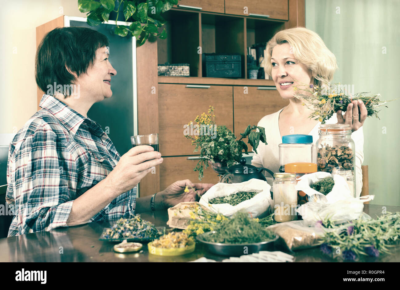 Two elderly neighbors drinking herbal tea for the health Stock Photo ...