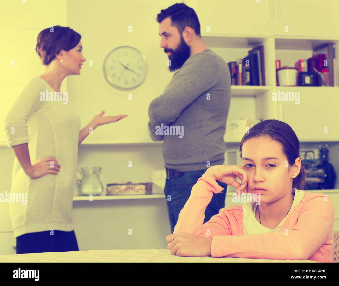 Young parents arguing with each other while their daughter at home ...