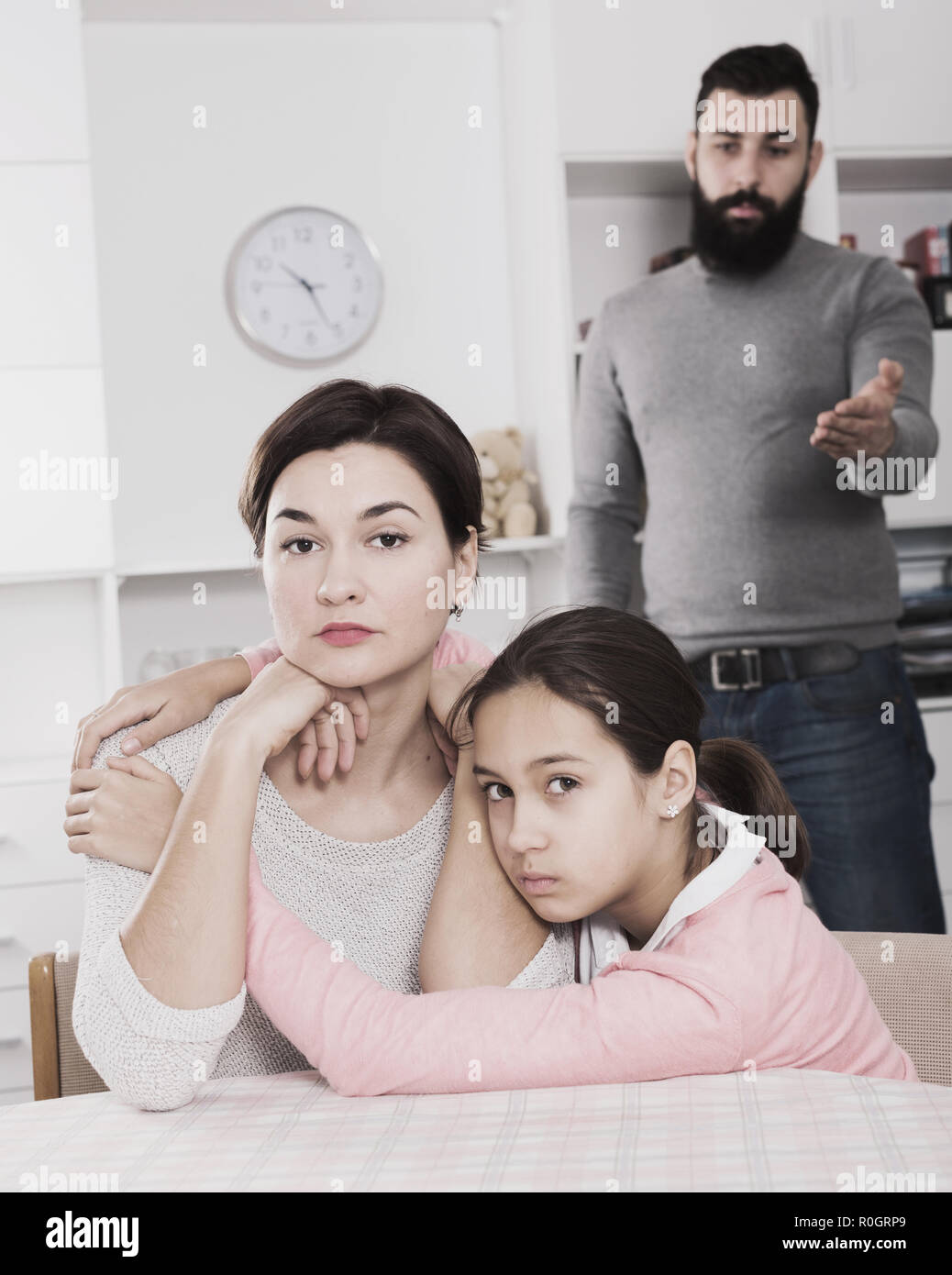Father telling off his wife and daughter for disobedience at home Stock ...