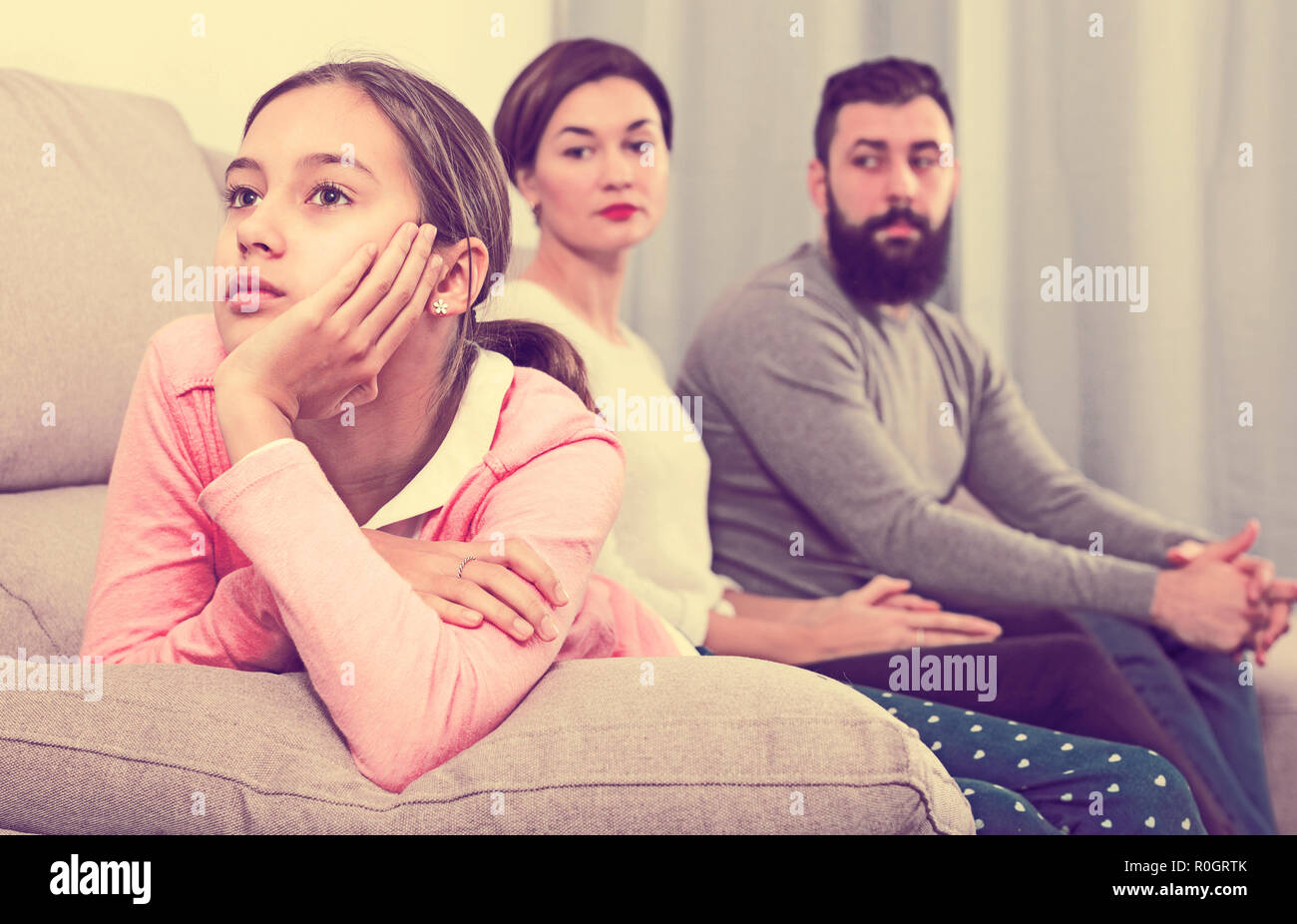 Young parents lecturing their daughter for bad behavior at home Stock ...