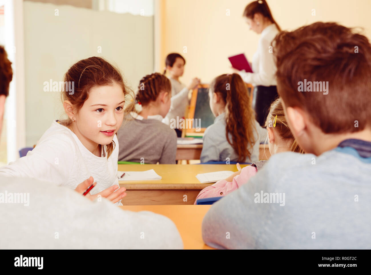 Portrait of children discussing something during lesson in school Stock ...