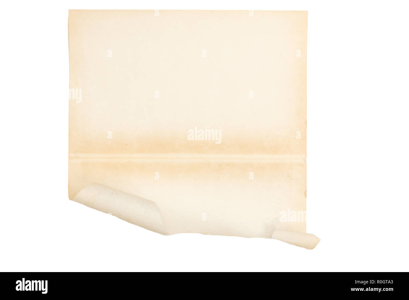 Sheet of old yellowed paper with inclusions, blemishes and uneven torn ...