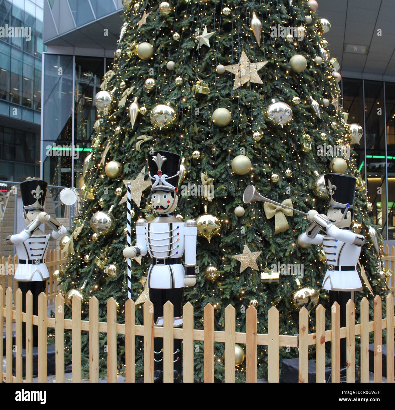 Christmas tree with gold decorations and white toy soldiers Stock Photo ...