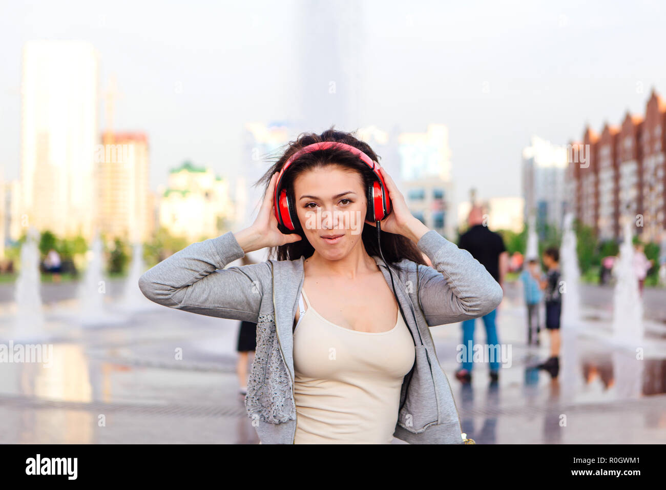 Girl listening to music streaming with headphones and dancing on the ...