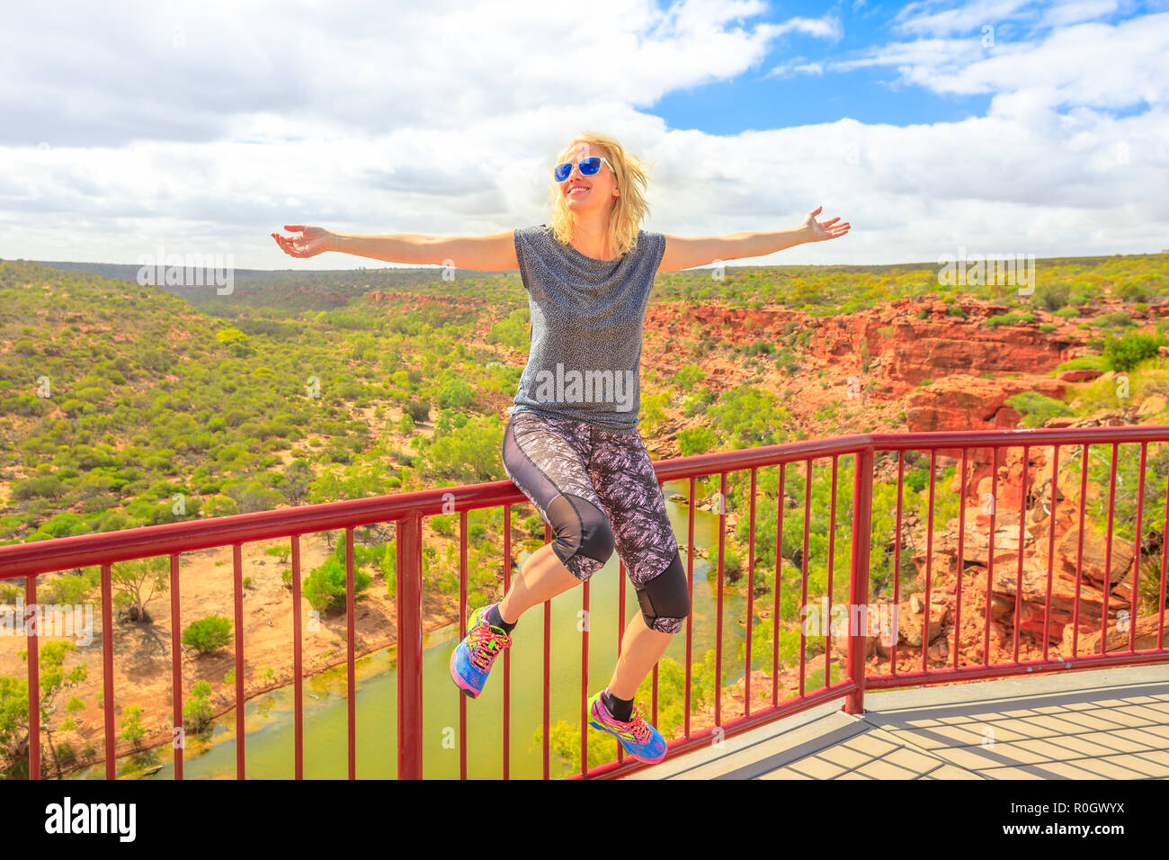 Blonde caucasian woman with open arms enjoys the Murchison River gorge ...