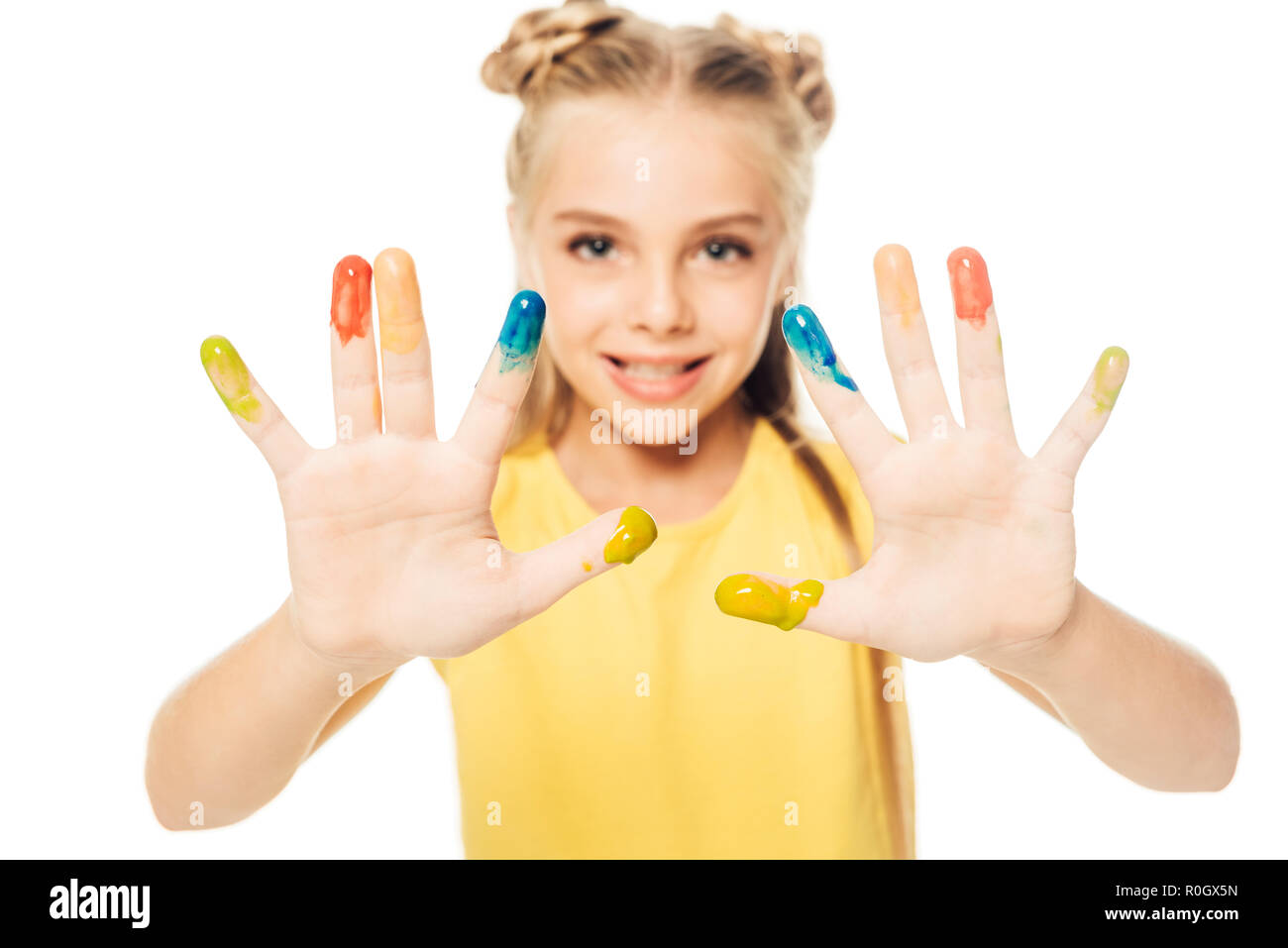 happy child showing colorful painted hands and smiling at camera ...