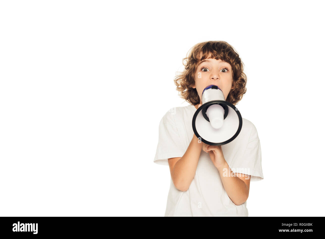 adorable child yelling in megaphone and looking at camera isolated on ...