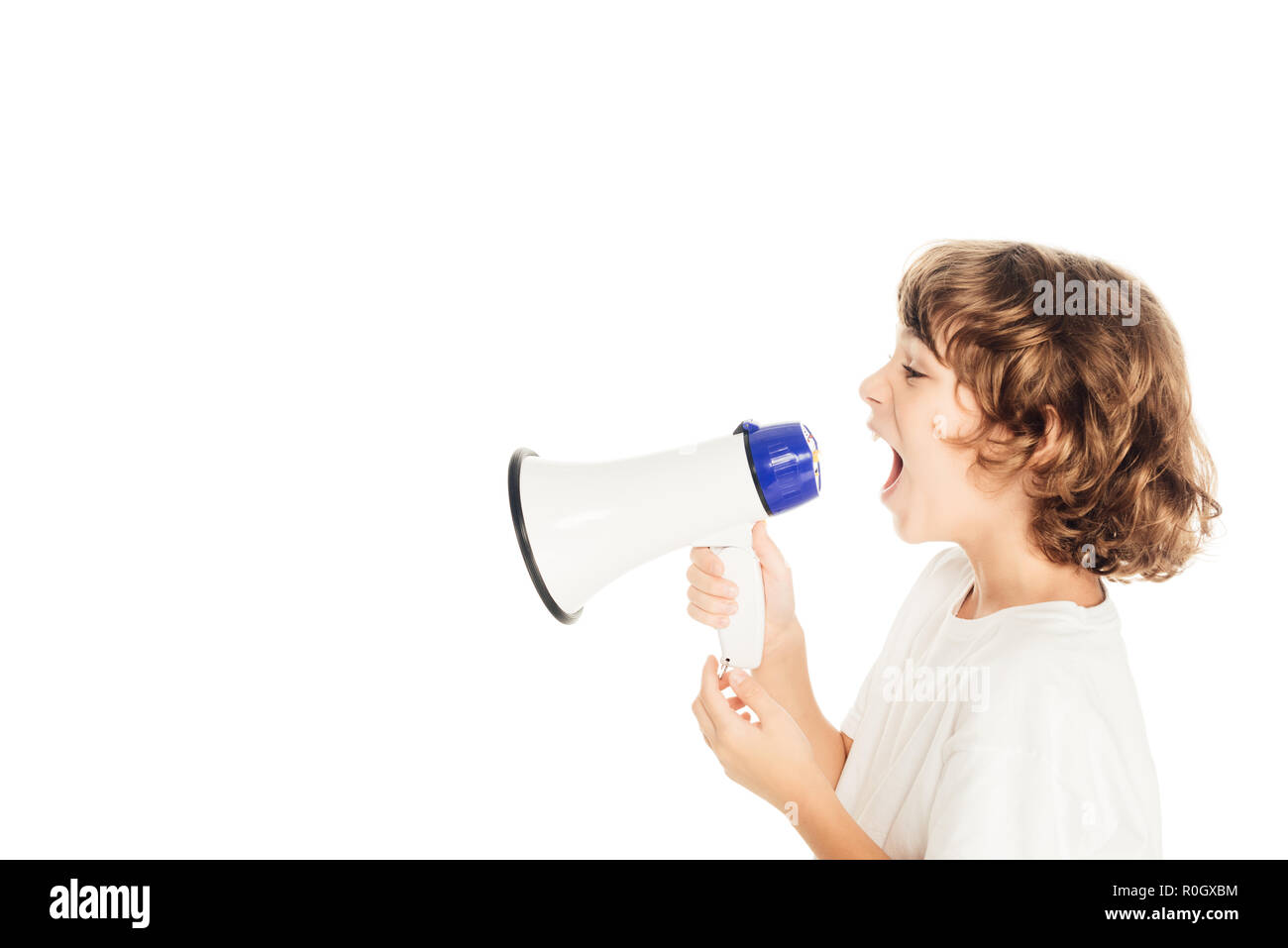 side view of cute little boy yelling in megaphone isolated on white ...