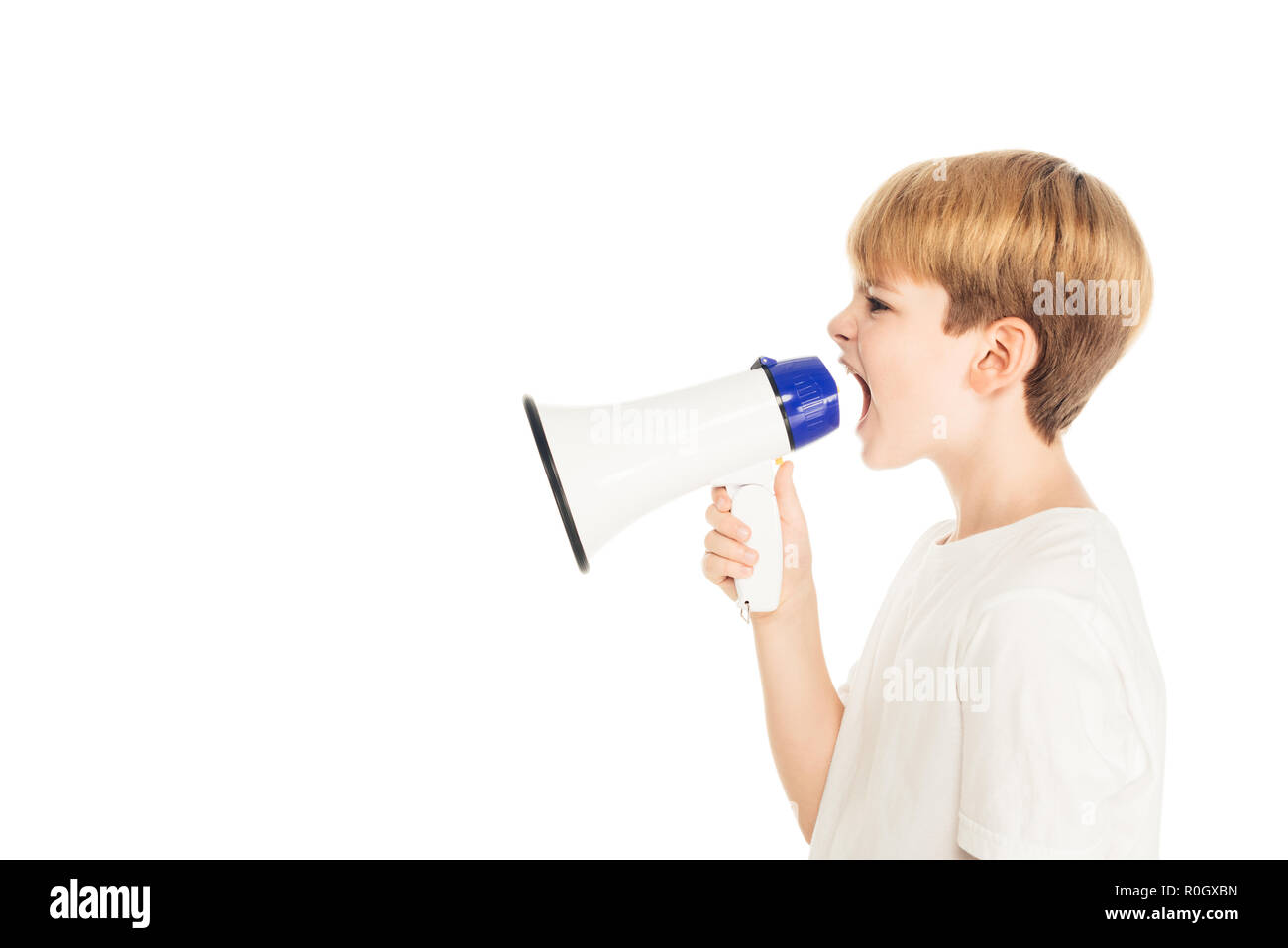 side view of adorable little boy screaming in megaphone isolated on ...